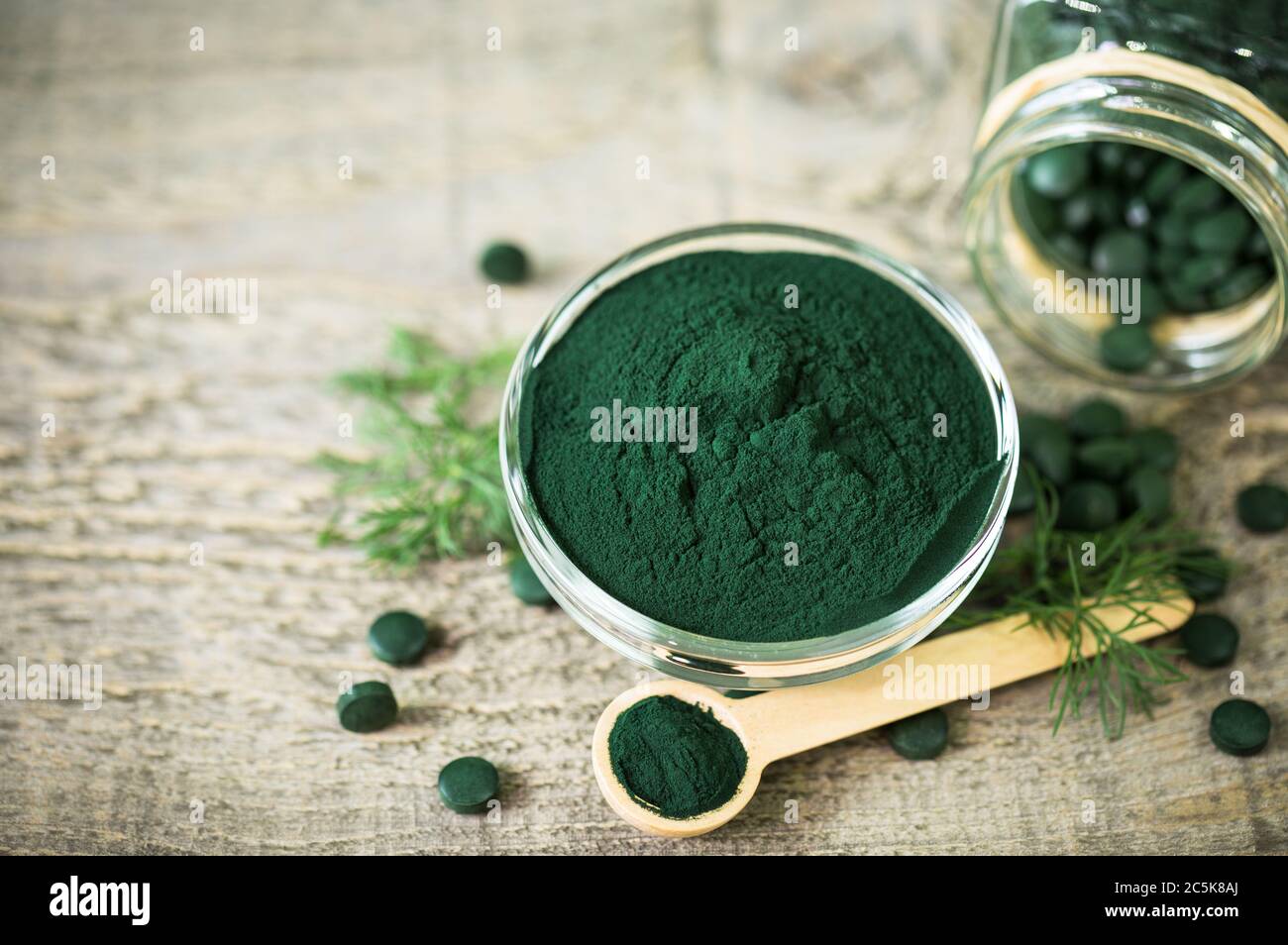 Spirulina tablets and powder in bowls Stock Photo - Alamy