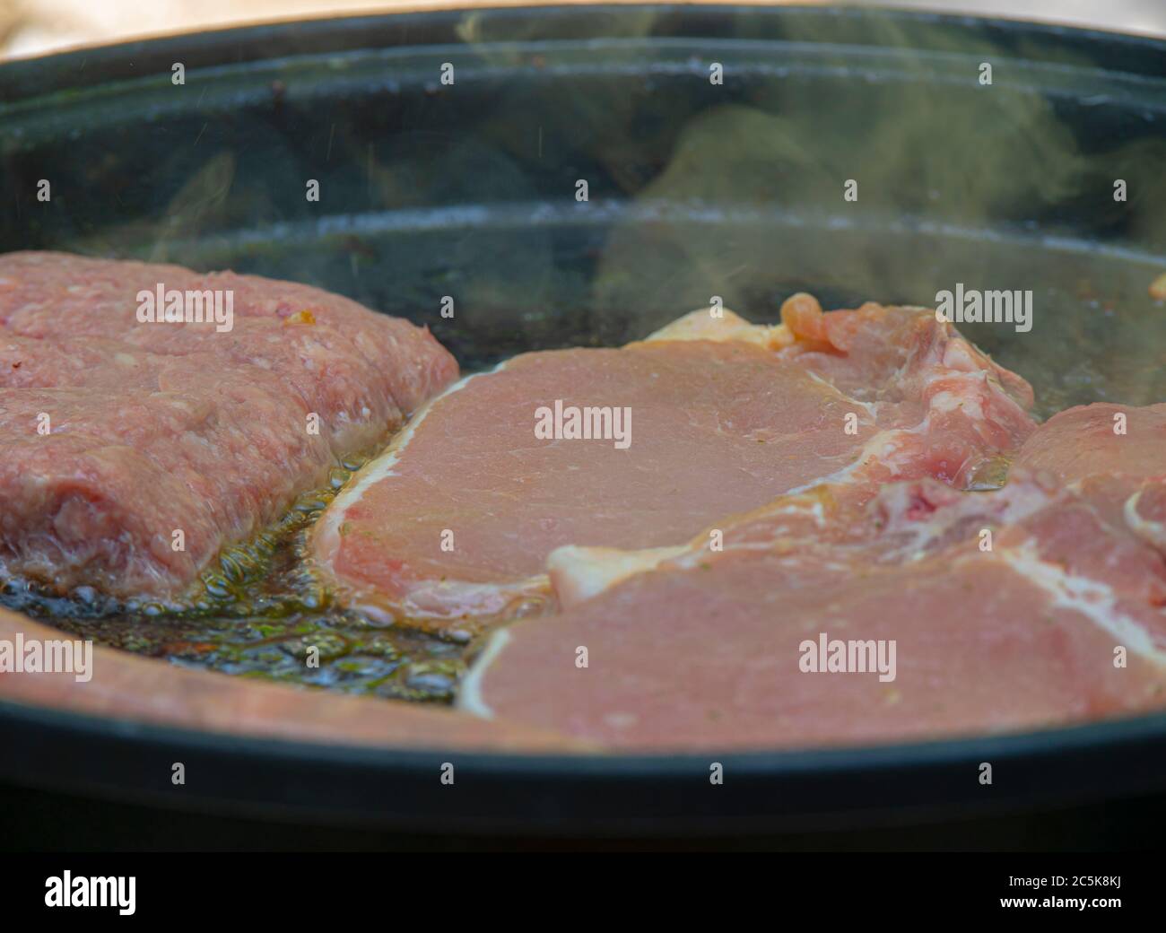 Cooking in electric meat grill close up Stock Photo - Alamy