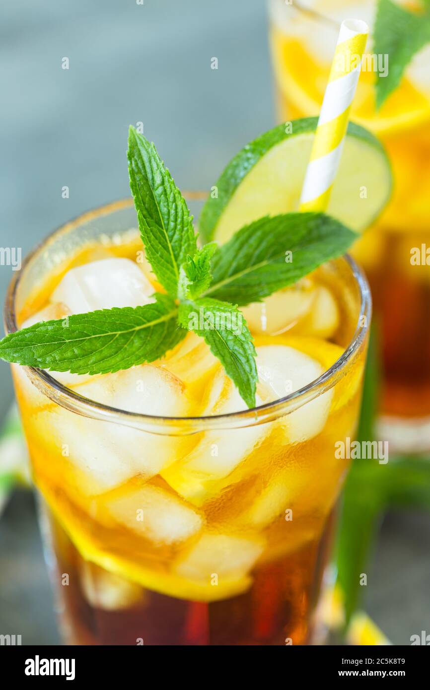 Homemade peach ice tea with ice, lime and mint in the glass Stock Photo ...