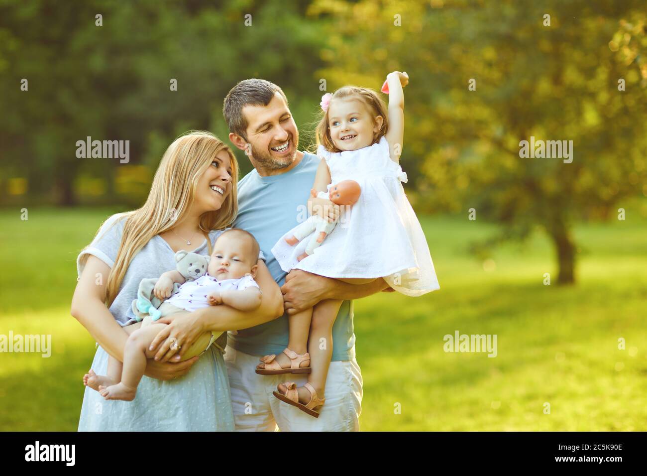 Happy family with baby outside hi-res stock photography and images - Alamy