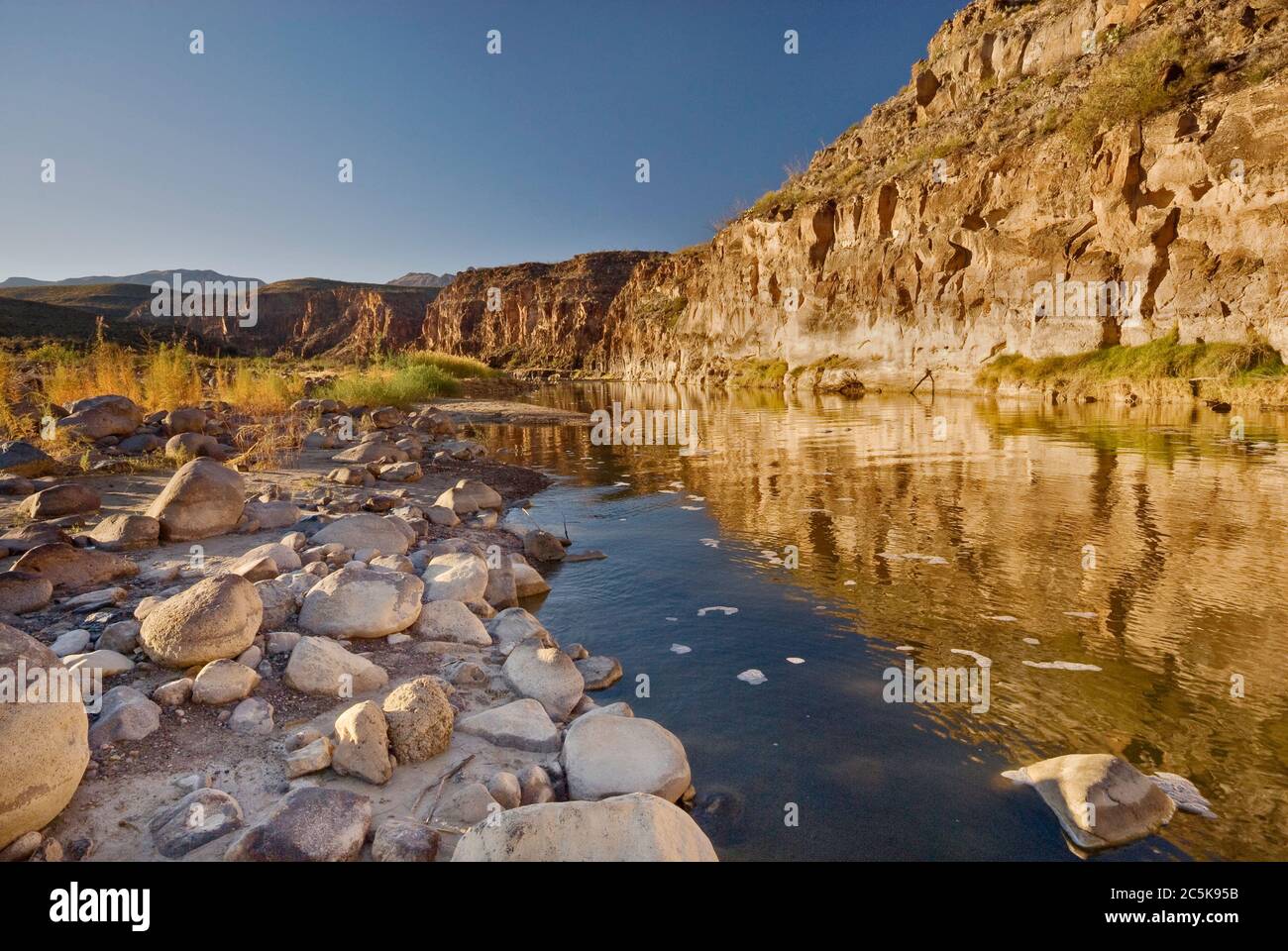 Rocky bank of Rio Grande in Colorado Canyon on The River Road, sunrise ...