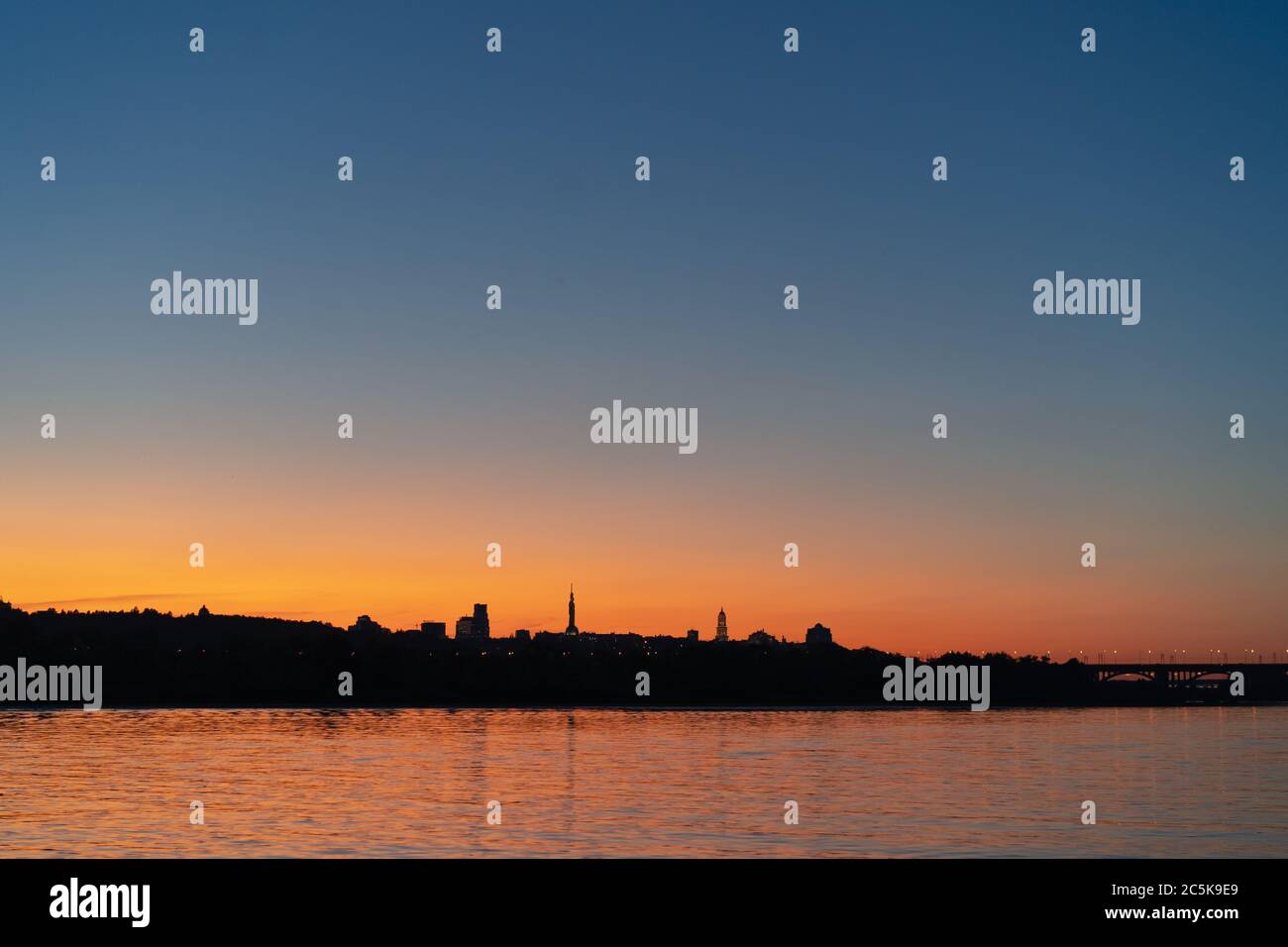 Sunset over Dnipro River. View on right bank of Dnieper. Cityscape with ...