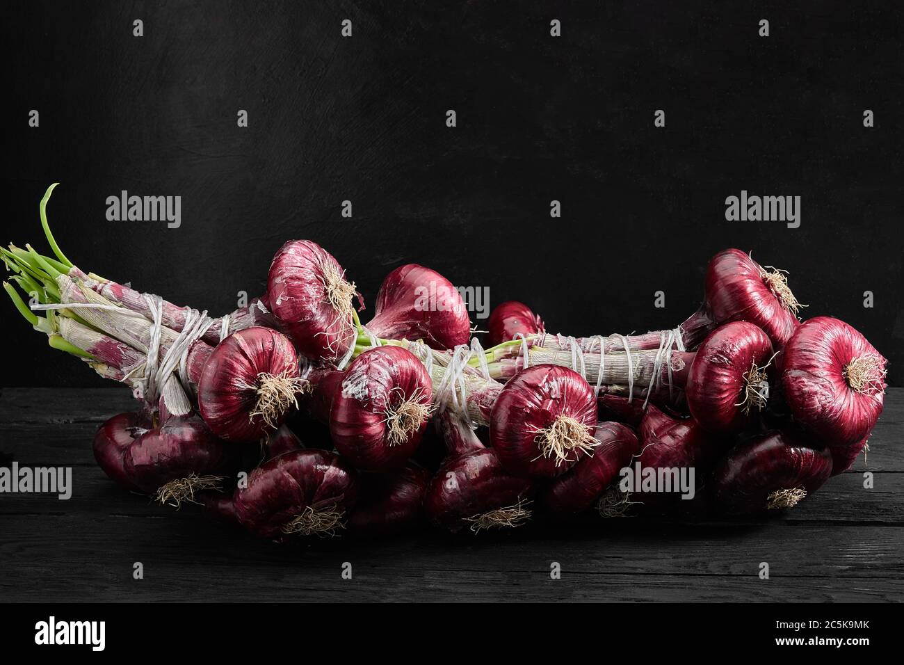 Red organic onion. Farm eco vegetables. Dark background Stock Photo - Alamy