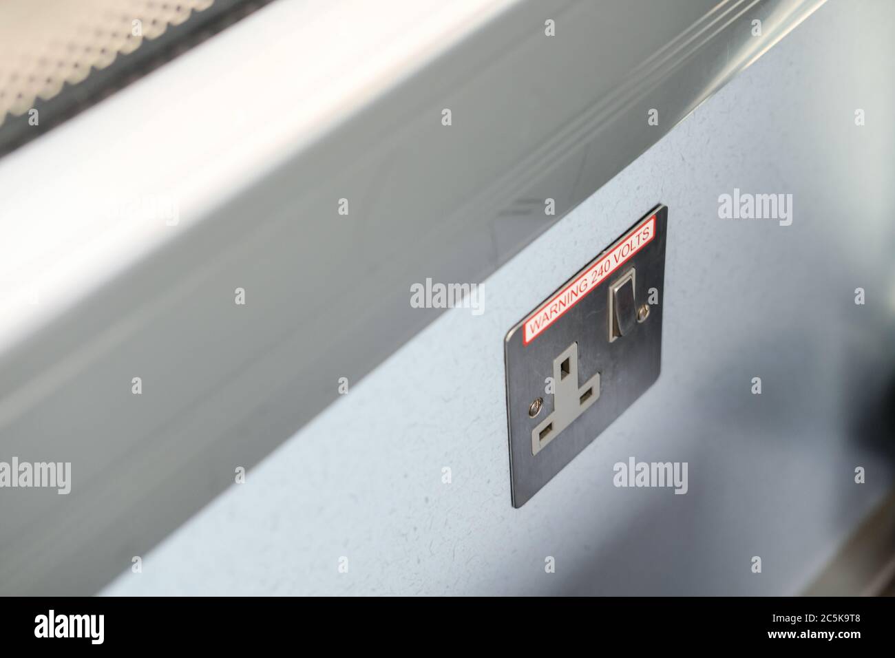 Shallow focus of a UK electrical wall outlet socket located in a ...