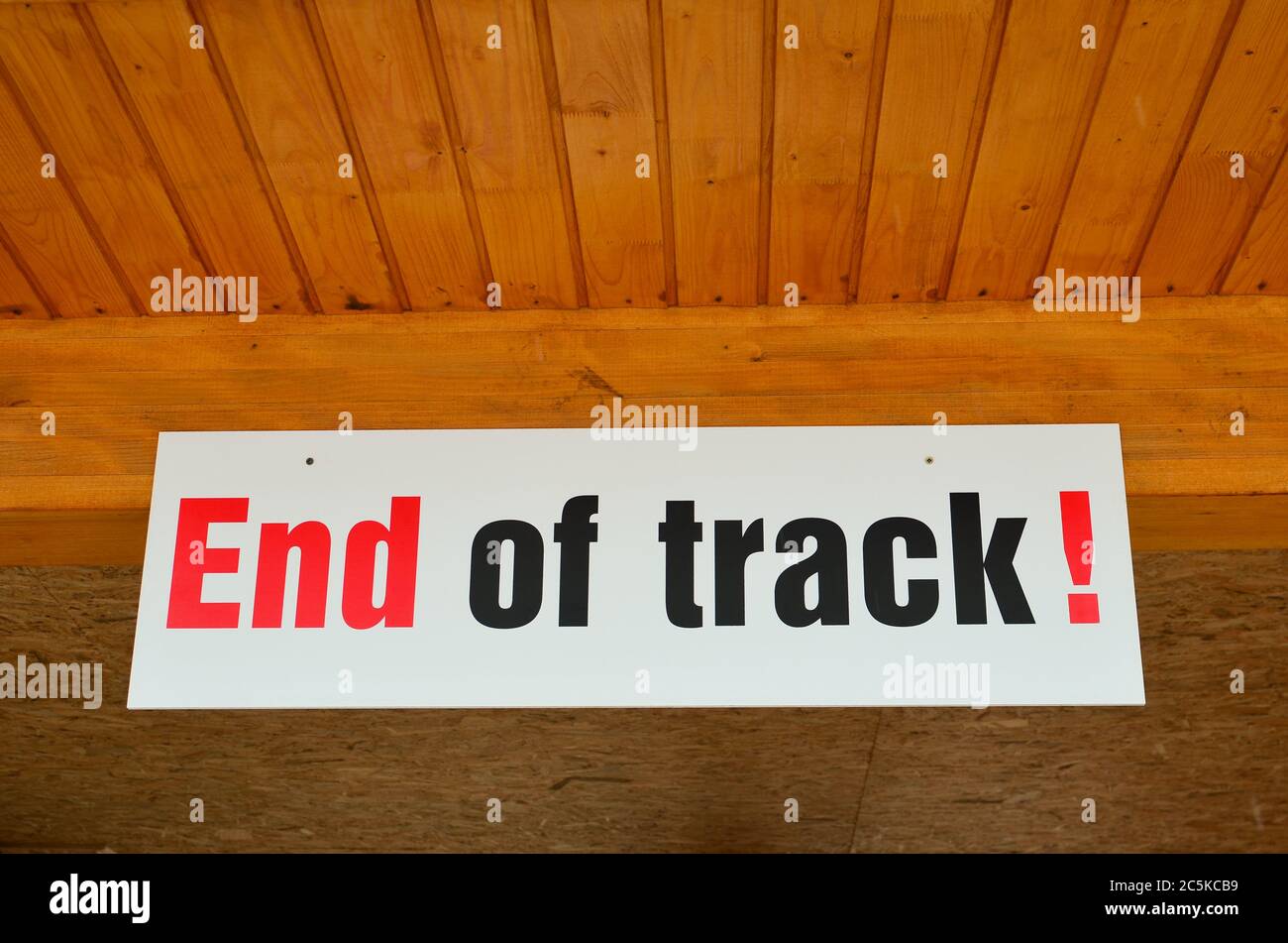 End of track warning sign written in red and blacklettershanged on a ...