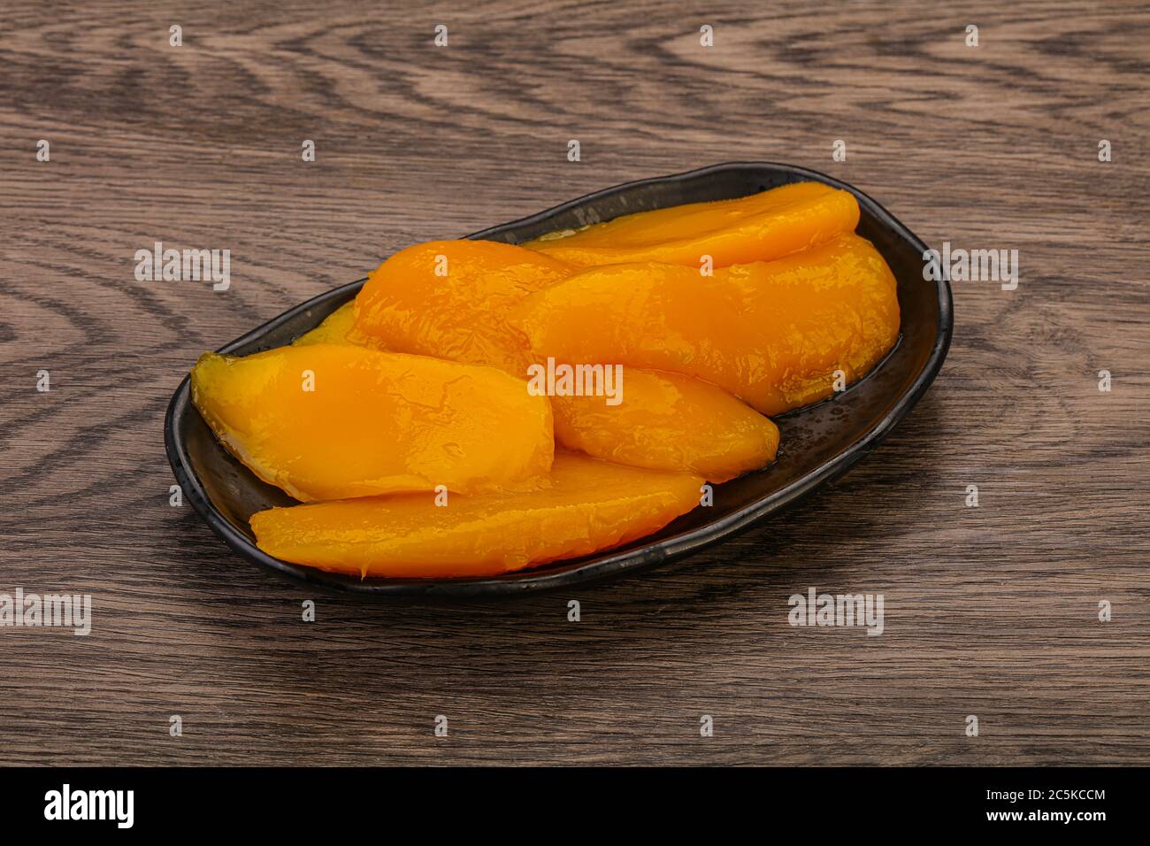 Sweet delicous mango slices in syrop Stock Photo - Alamy