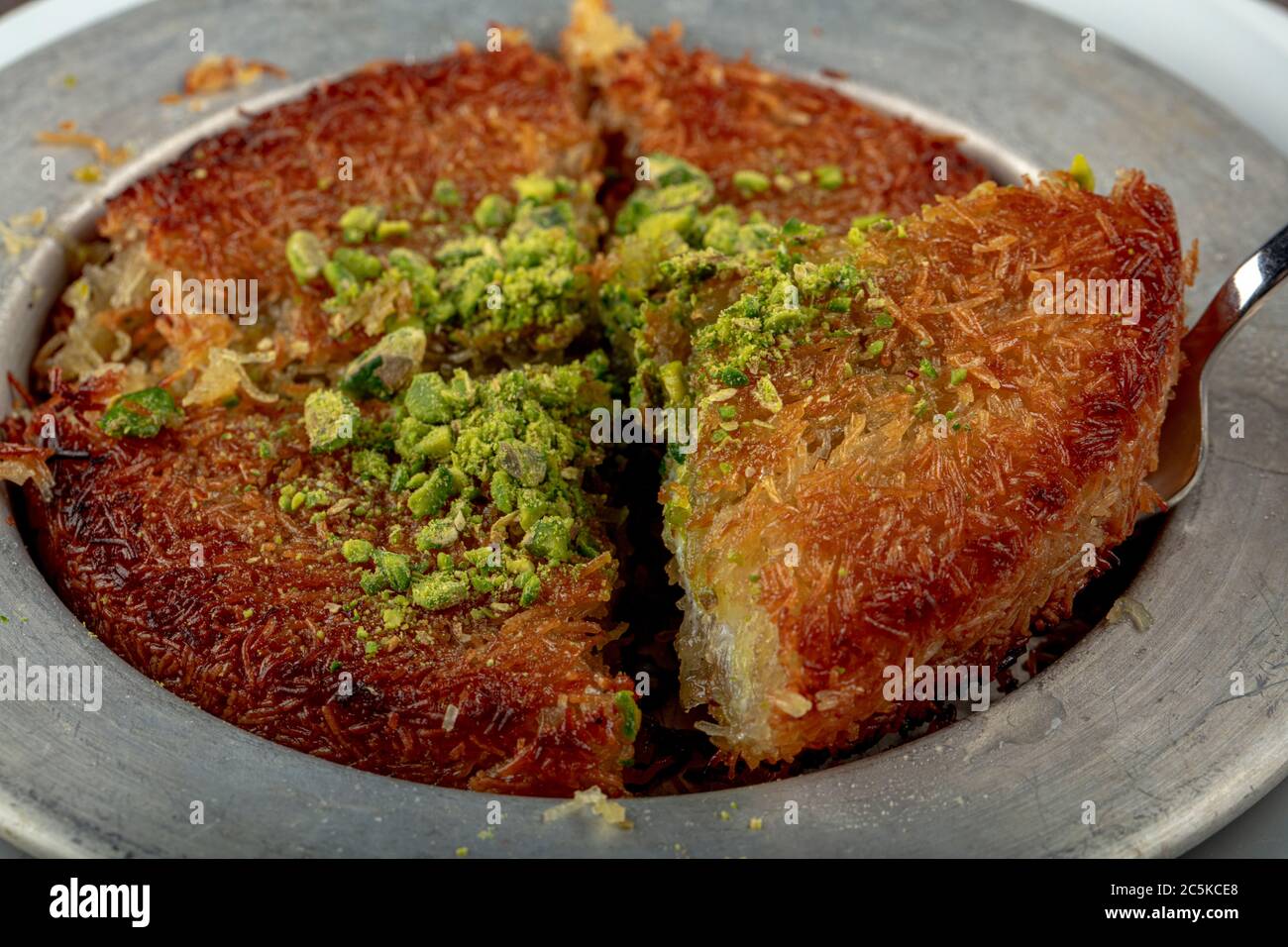 Turkish dessert kunefe, kunafa, kadayif with pistachio powder and ...
