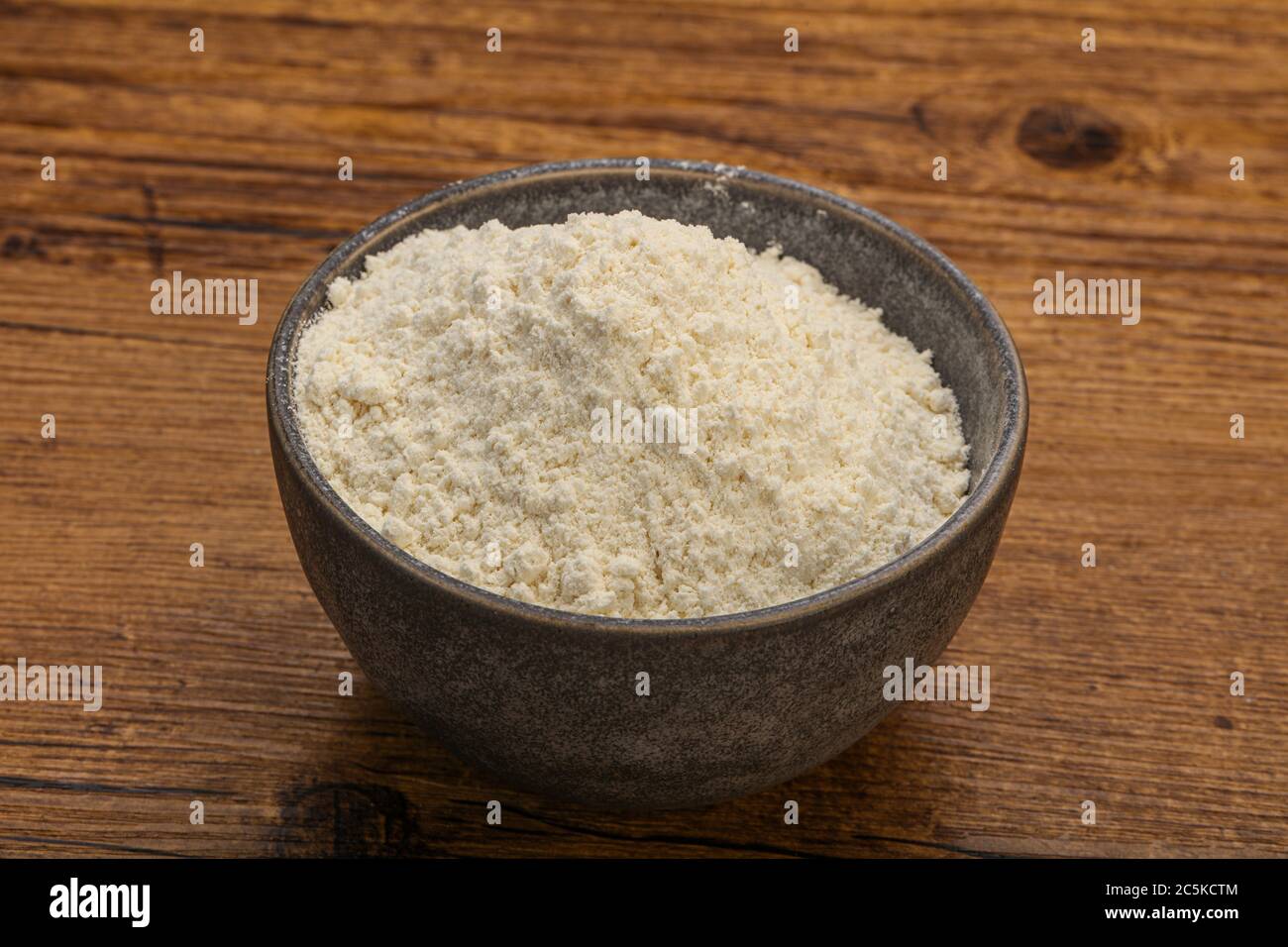 Wheat flour heap in the bowl for cooking Stock Photo - Alamy