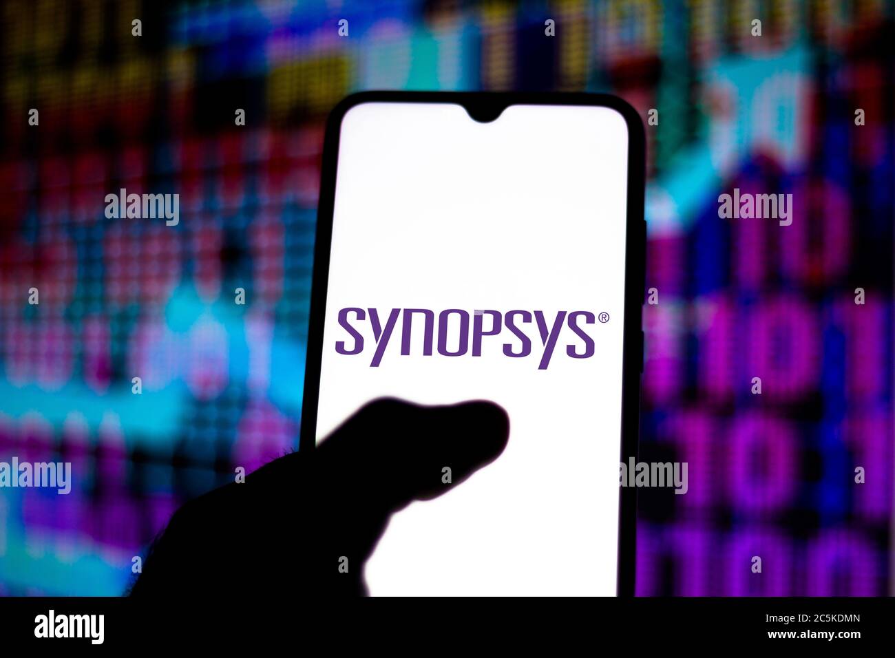 In this photo illustration the Synopsys logo seen displayed on a ...