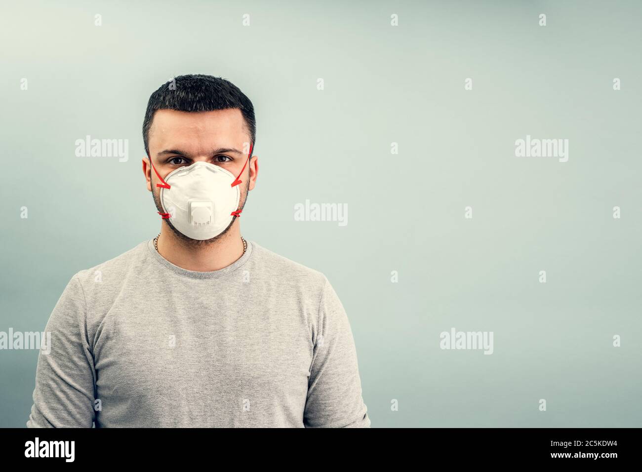 A man is putting on a protective mask. Respiratory protection from ...