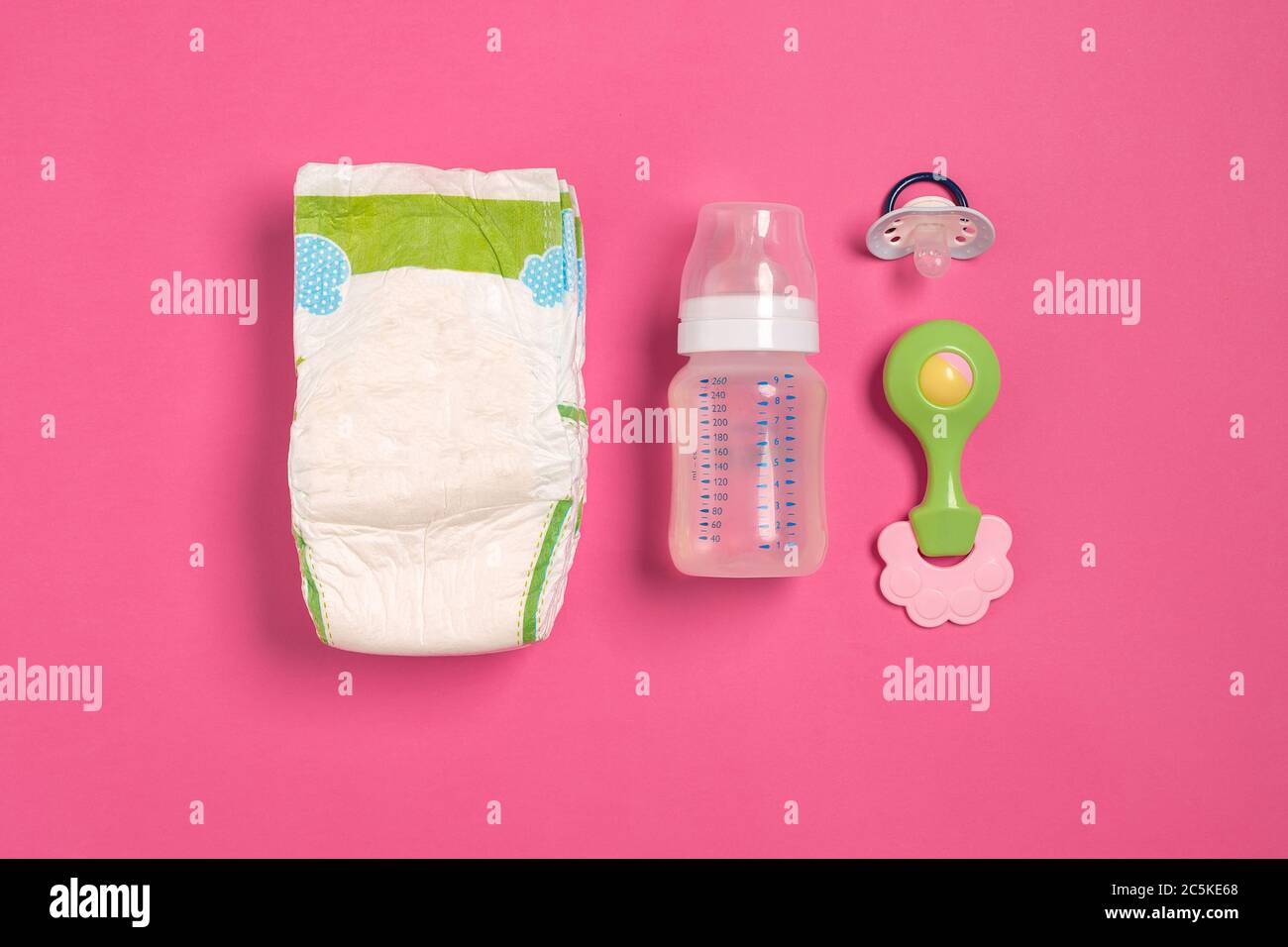 Baby care accessories and diapers on pink background. Top view Stock ...