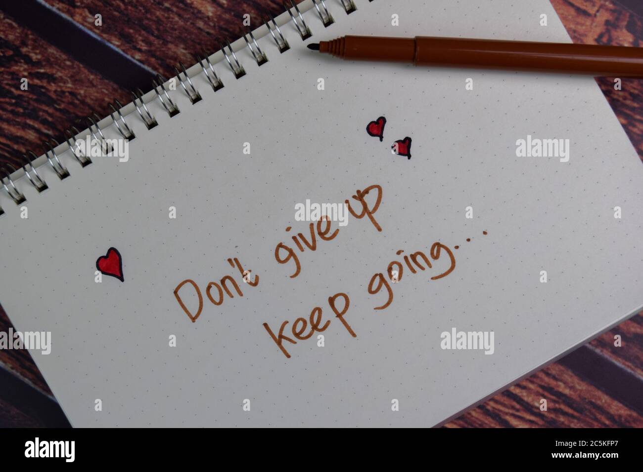 Don't Give up Keep Going write on a book isolated wooden table Stock ...