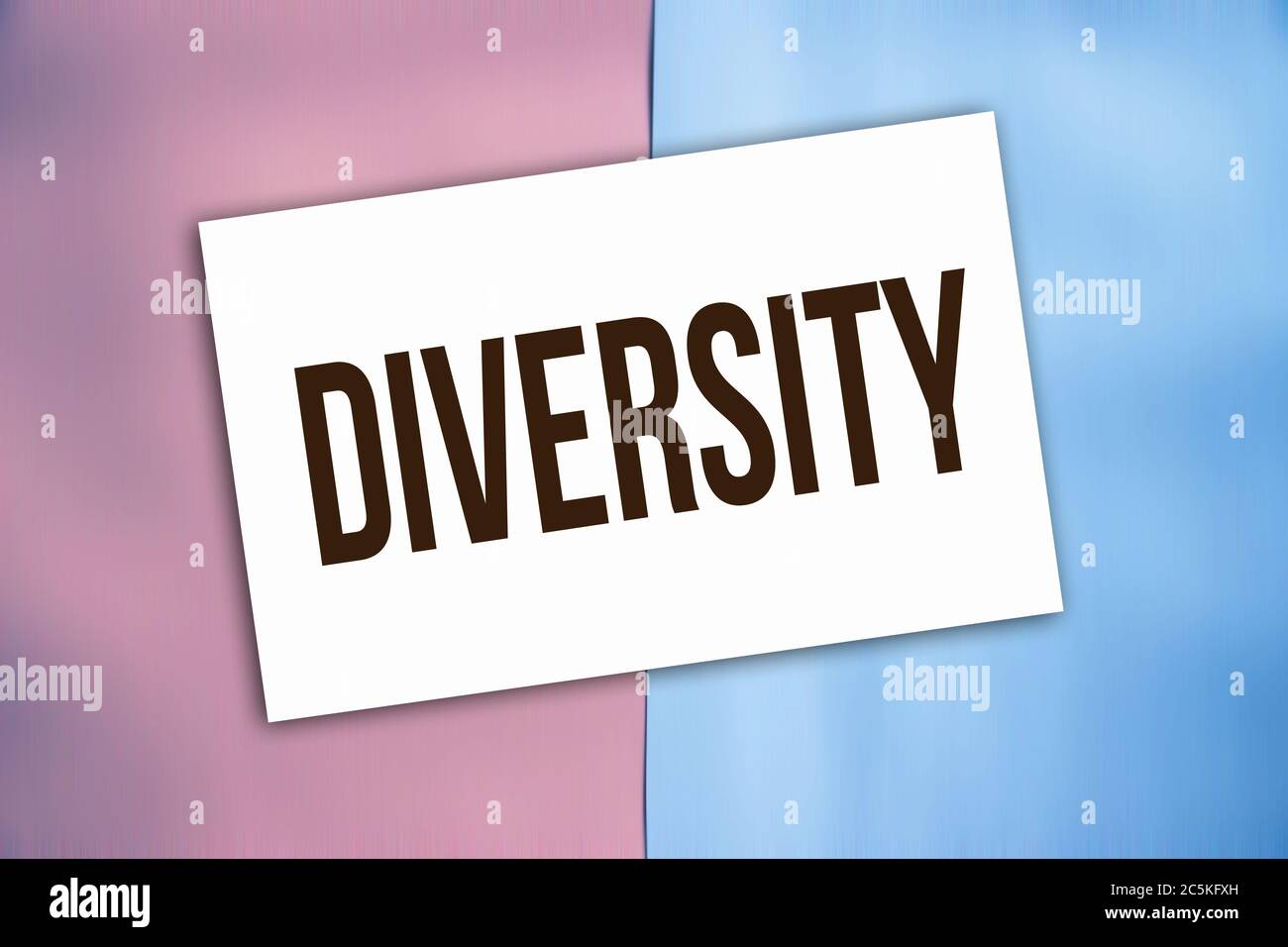 Diversity word on card put on pink and baby blue background. Teamwork ...