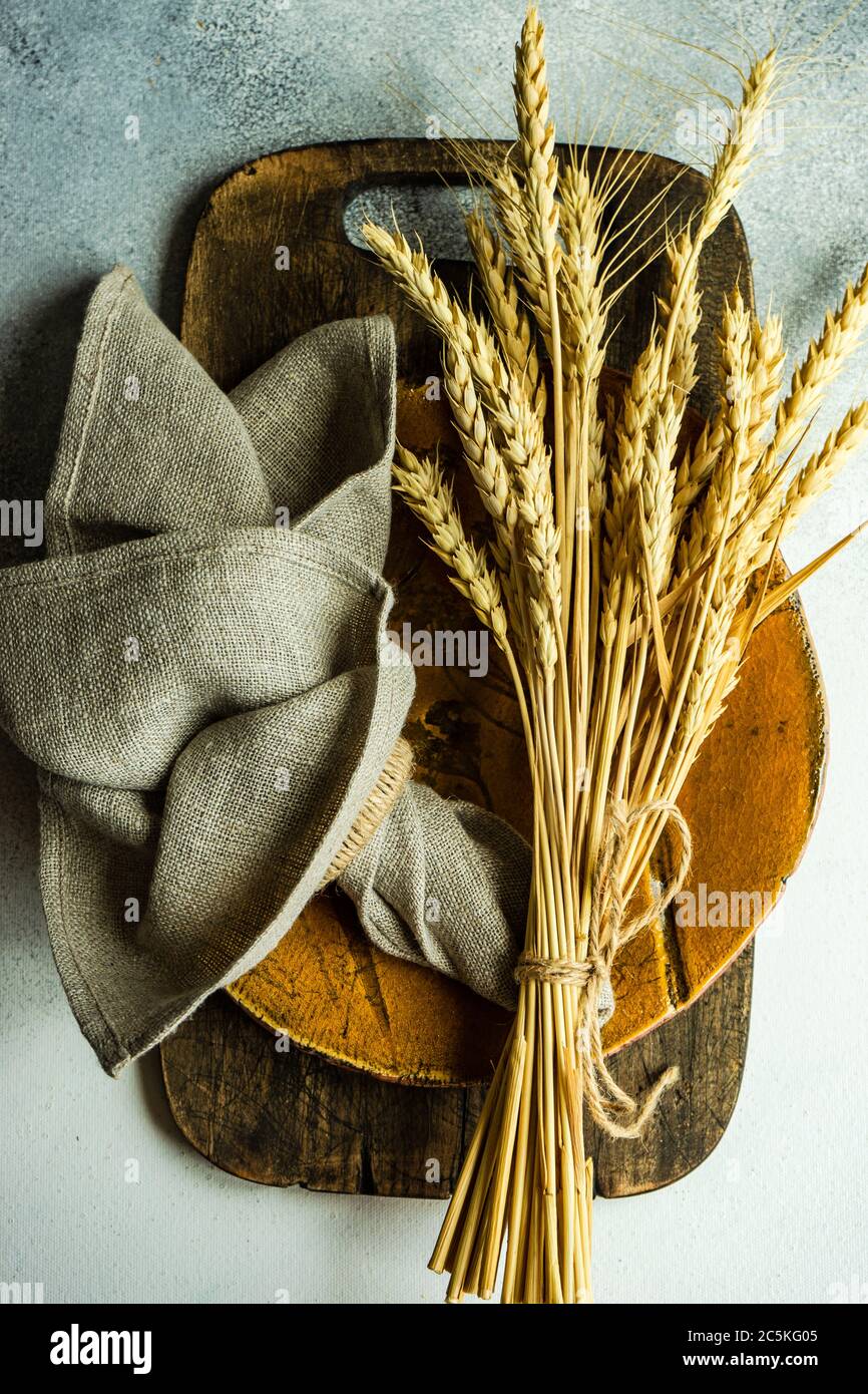 Rustic table setting with cutlery decorated with whear ears on concrete ...