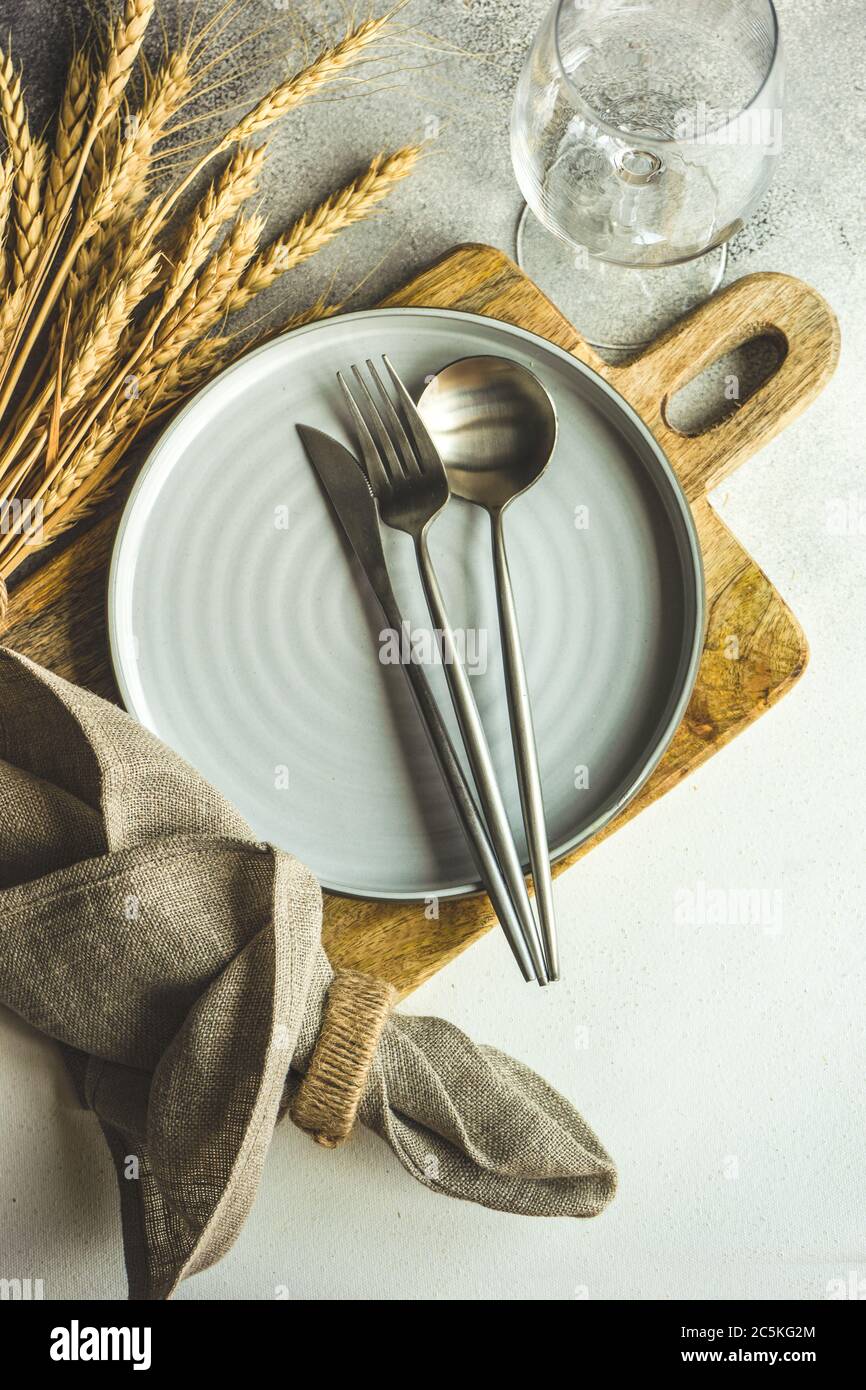 Rustic table setting with cutlery decorated with whear ears on concrete ...