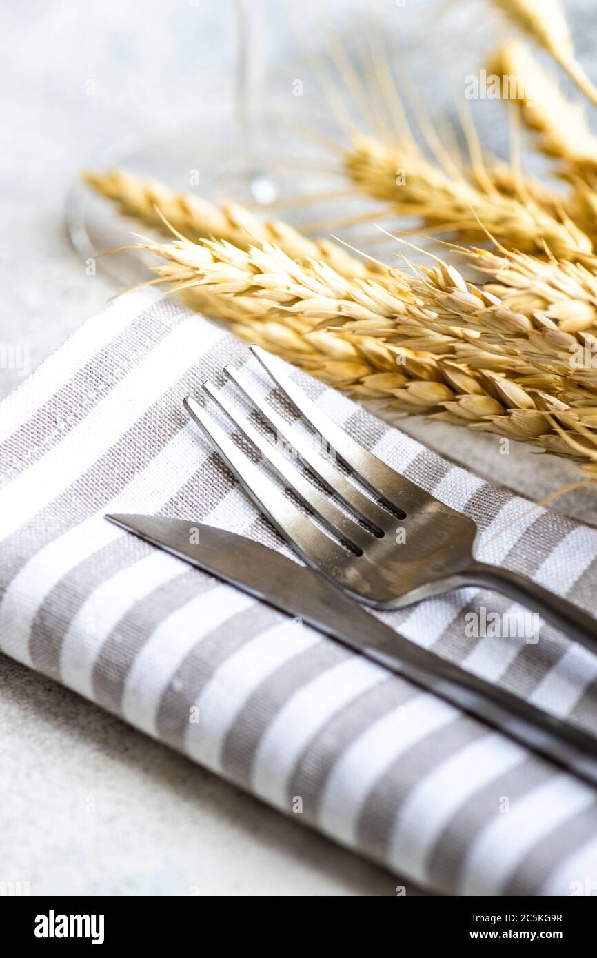 Rustic table setting with cutlery decorated with whear ears on concrete ...