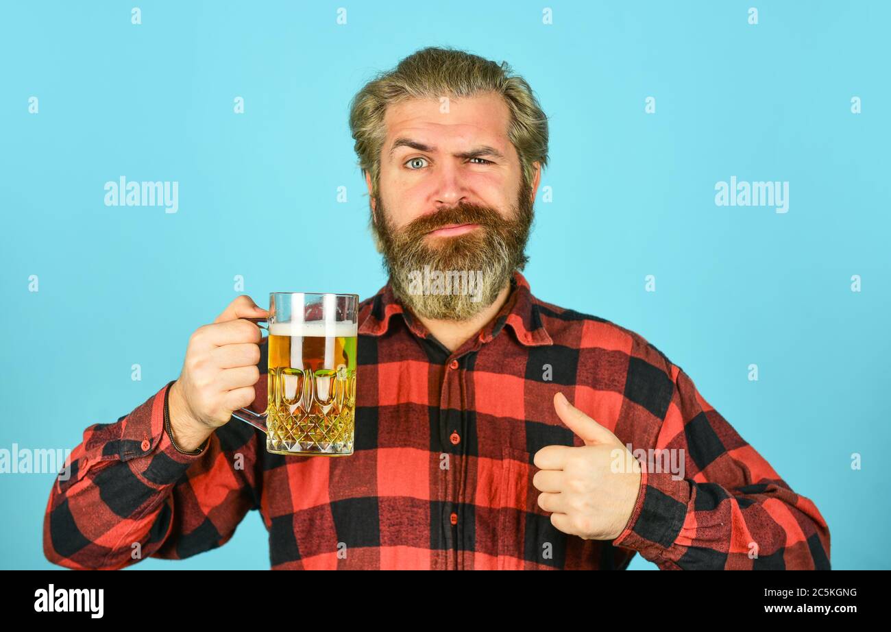lager beer. relaxed handsome man sipping delicious beer. enjoying glass ...