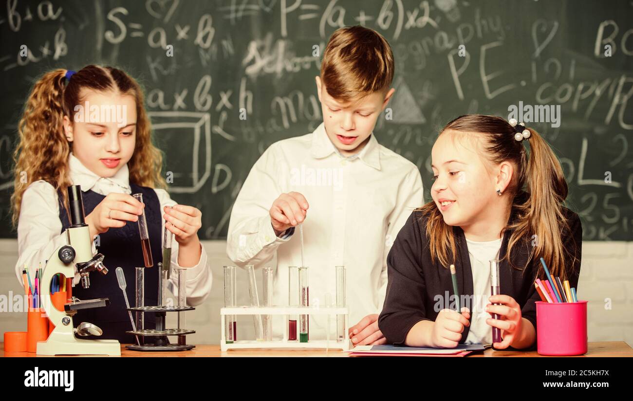 Girls and boy student conduct school experiment with liquids. School ...