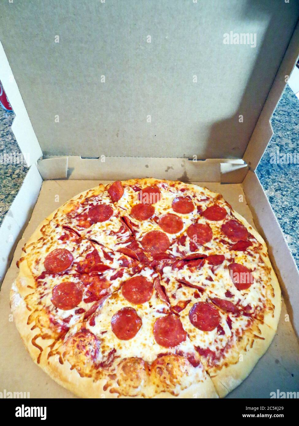 Box filled with a fresh pepperoni pizza Stock Photo - Alamy