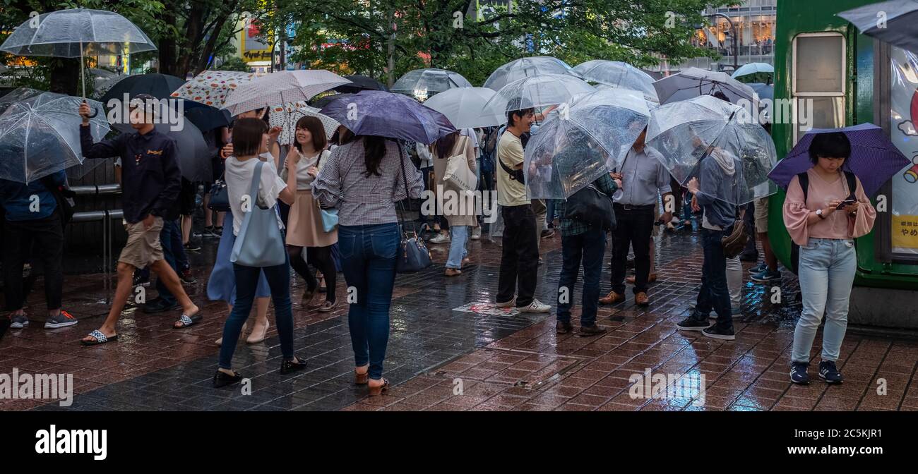 Pedestrian crowd with umbrellas at Hachiko Square, Tokyo, Japan during ...