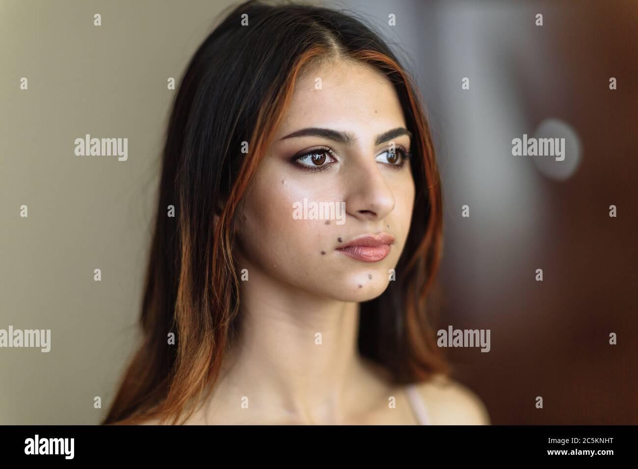 Beautiful model in make up process. Portrait of young pretty woman with ...
