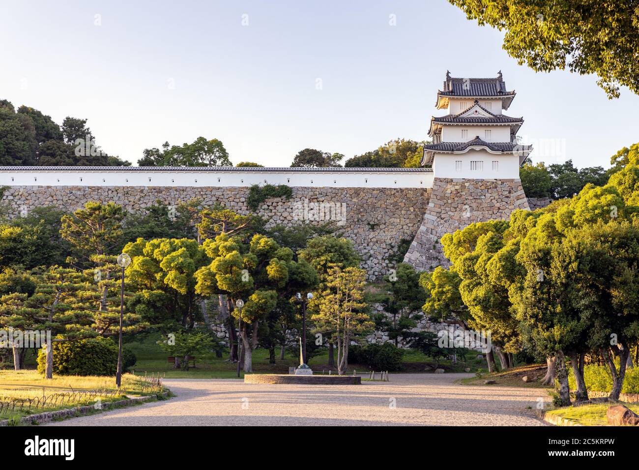 Ancient castle tower rises above trees in empty park Stock Photo - Alamy