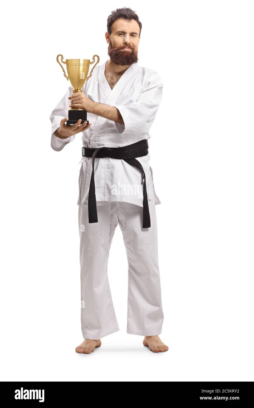 Full length portrait of a karate champion in kimono with a trophy cup ...
