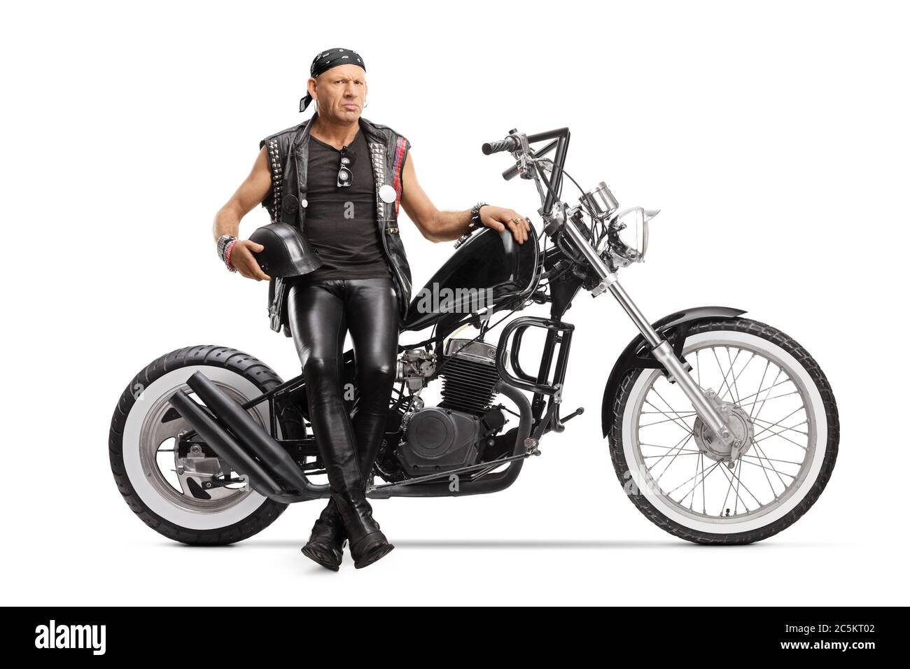 Punk biker sitting on a chopper motorbike isolated on white background ...