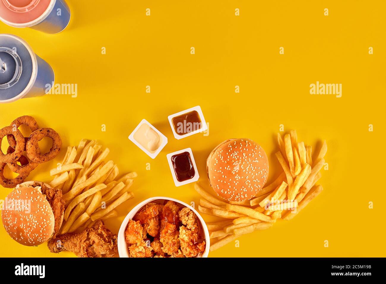 Fast food dish top view. Meat burger, potato chips and wedges. Take ...