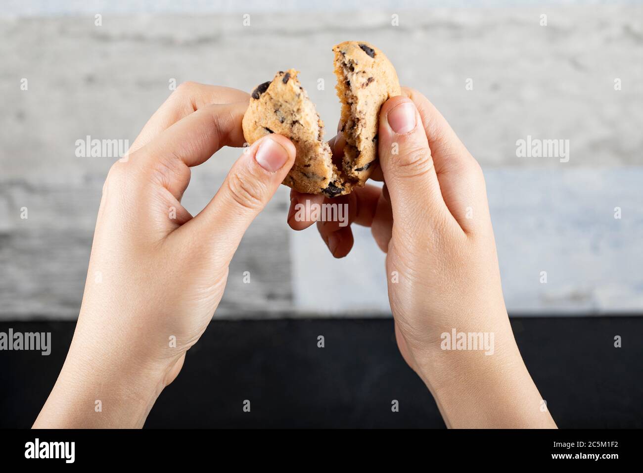 Cutting a butter cookie into pieces Stock Photo - Alamy
