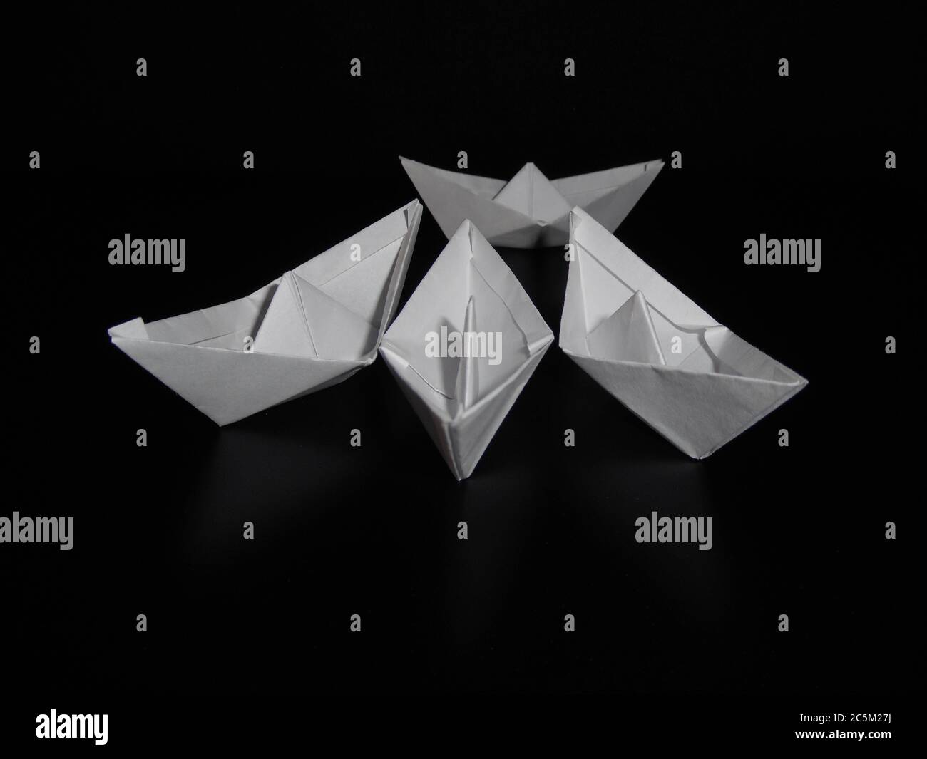paper boats,over background as black Stock Photo - Alamy