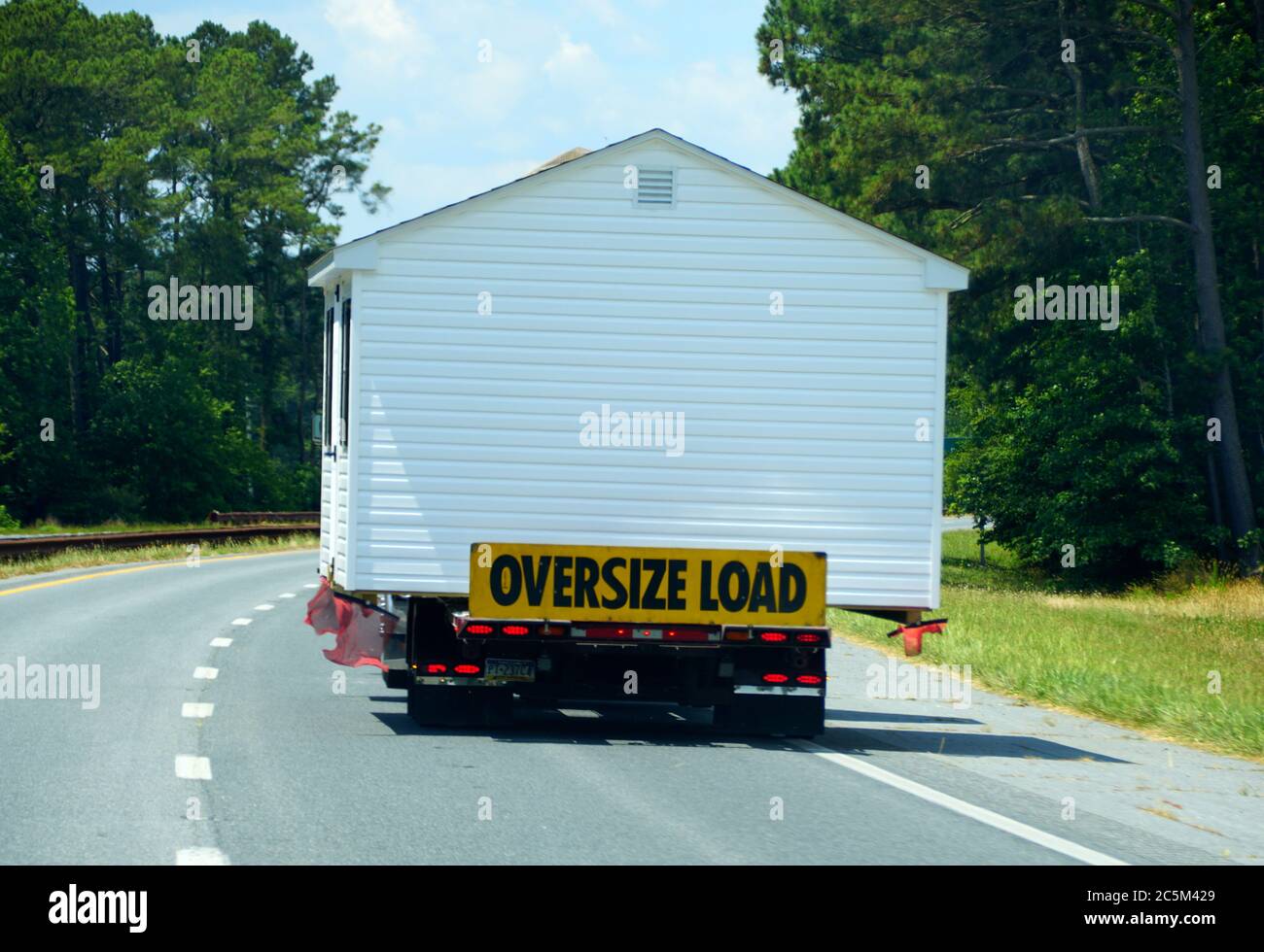 Virginia, U.S.A - June 29, 2020 - A trailed house marked oversize load ...
