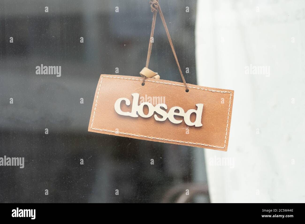 sorry we are closed sign hanging outside a restaurant, store, office or ...