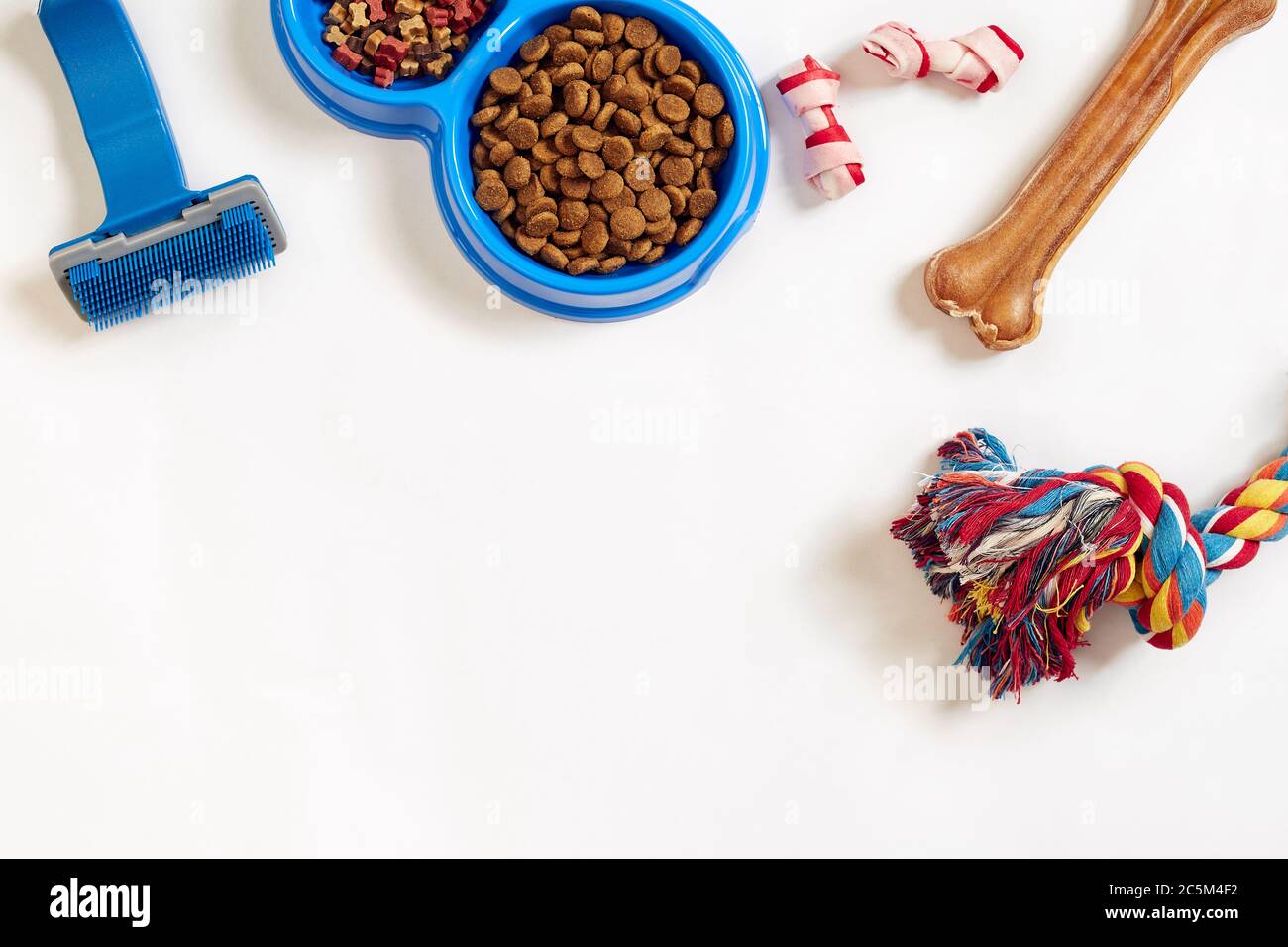 Dog care items, isolated on white background. Dry pet food in bowl, toy ...