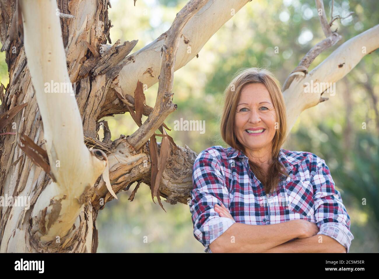 Portrait attractive mature woman in rural country, wearing plaid shirt ...