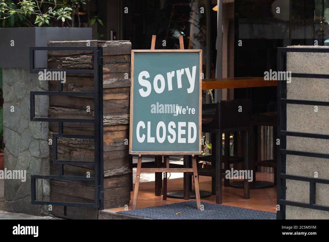 sorry we are closed sign hanging outside a restaurant, store, office or ...