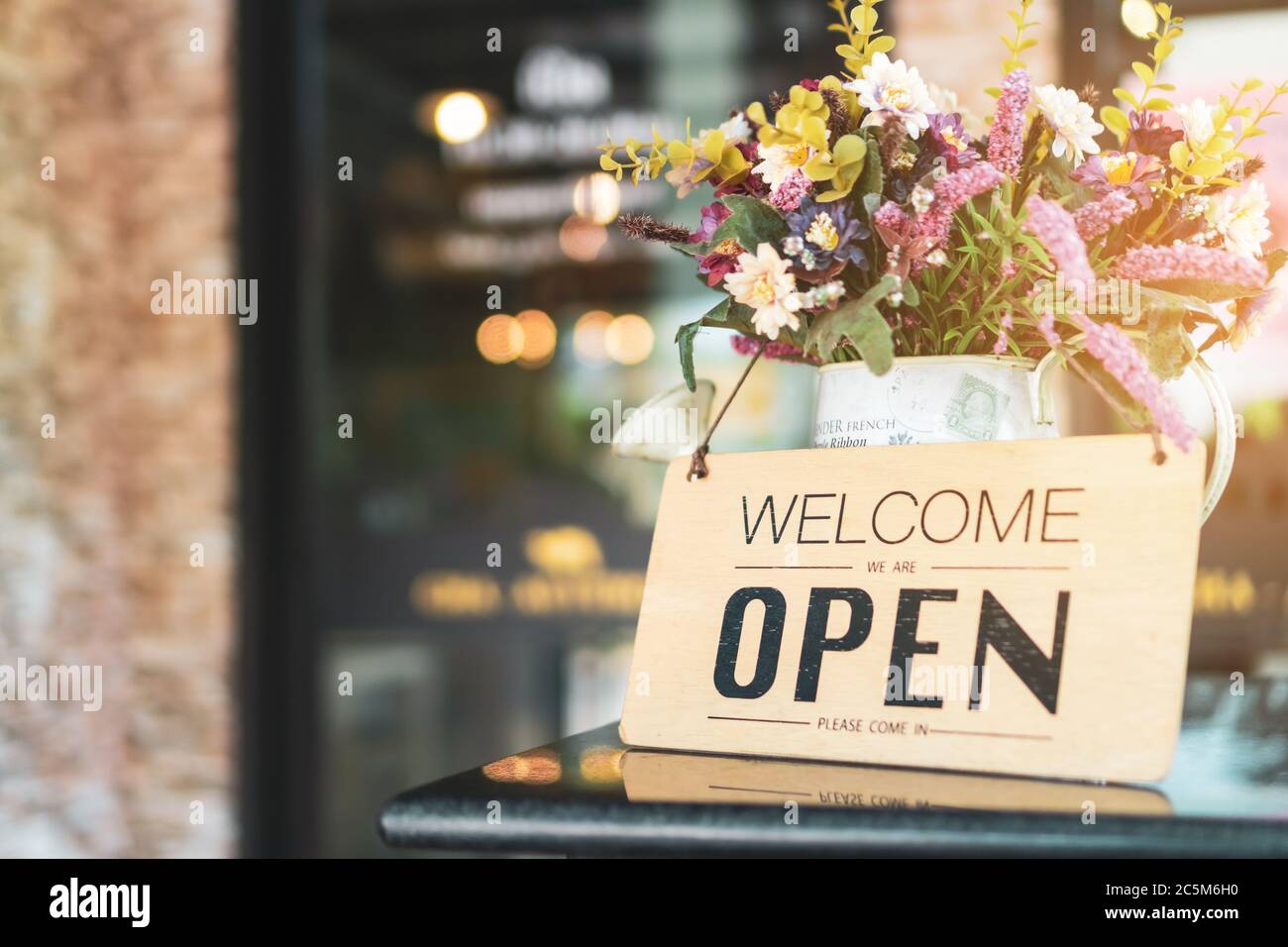 A business sign that says open on cafe or restaurant hang on door at ...
