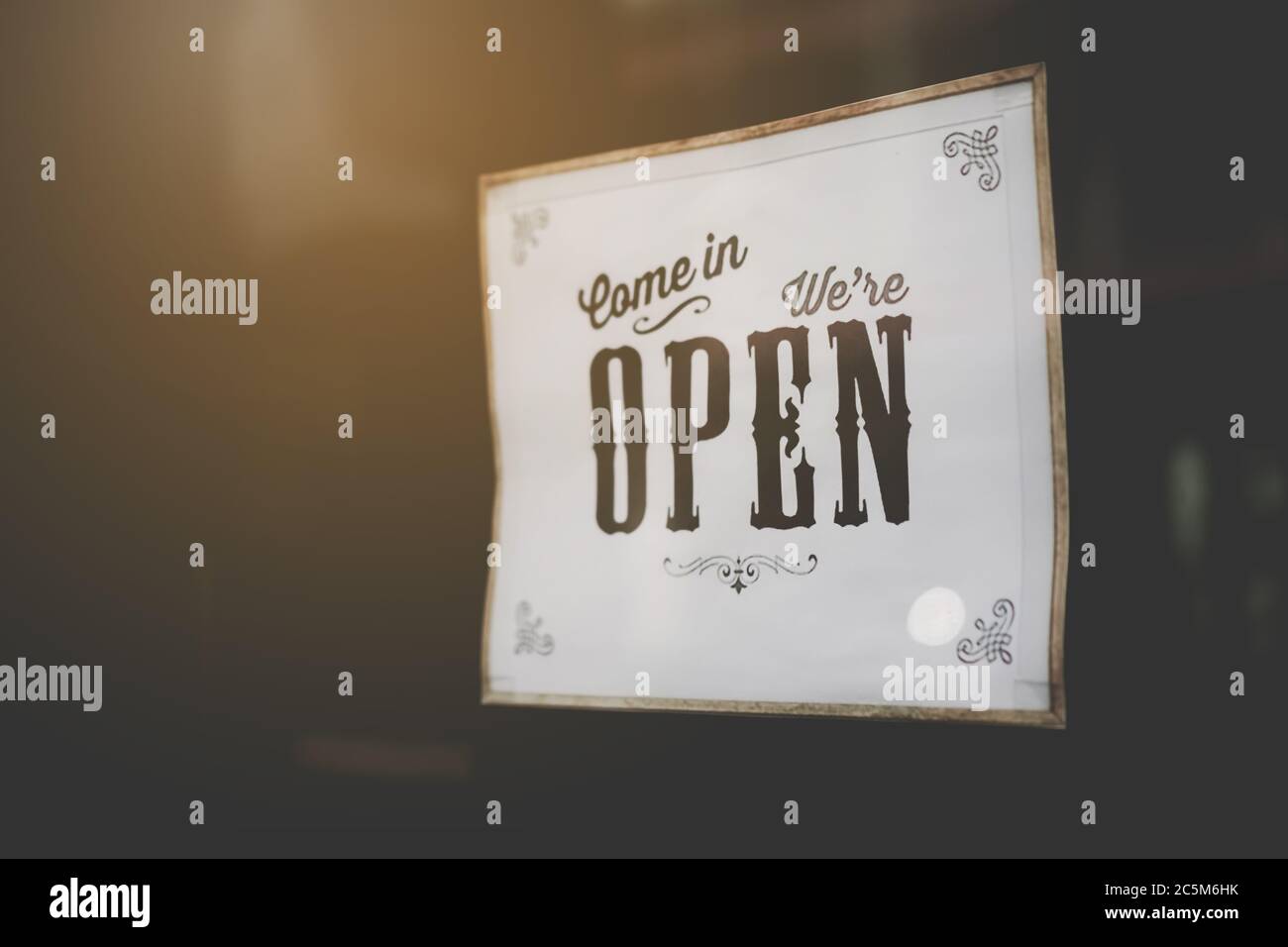 A business sign that says open on cafe or restaurant hang on door at ...