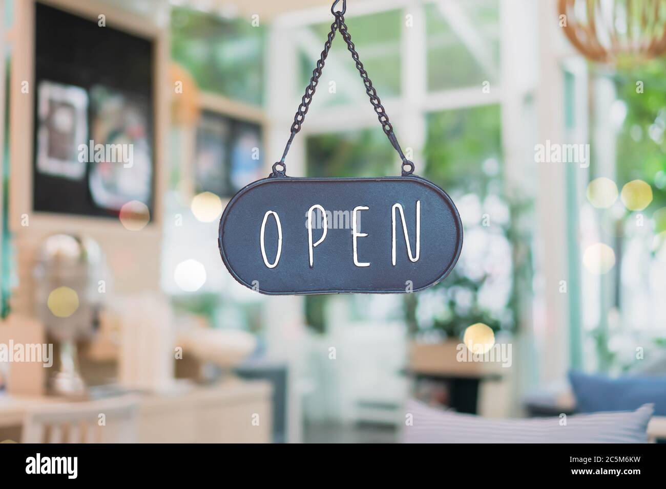 A business sign that says open on cafe or restaurant hang on door at ...