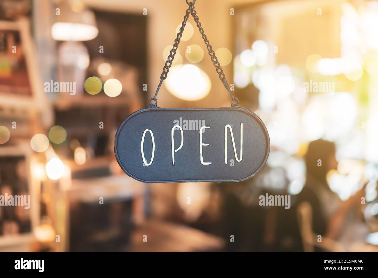 A business sign that says open on cafe or restaurant hang on door at ...