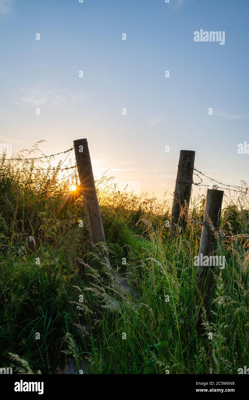 Sunset through a fence footpath stile opposite silbury hill at sunset ...