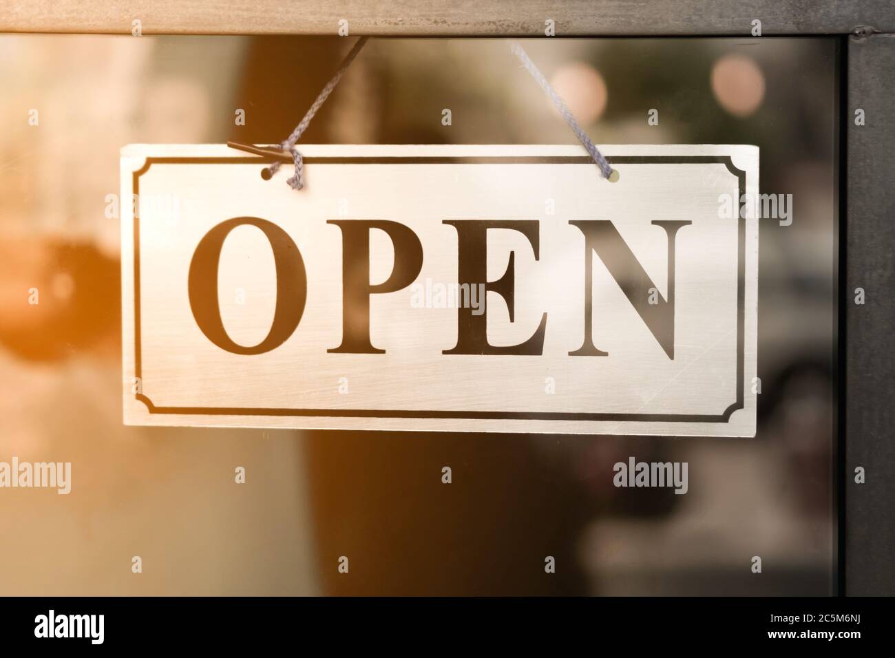 A business sign that says open on cafe or restaurant hang on door at ...