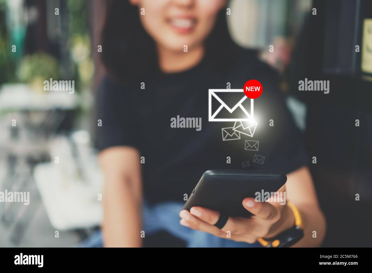 Woman hand using smartphone and it's show email recieve notification ...