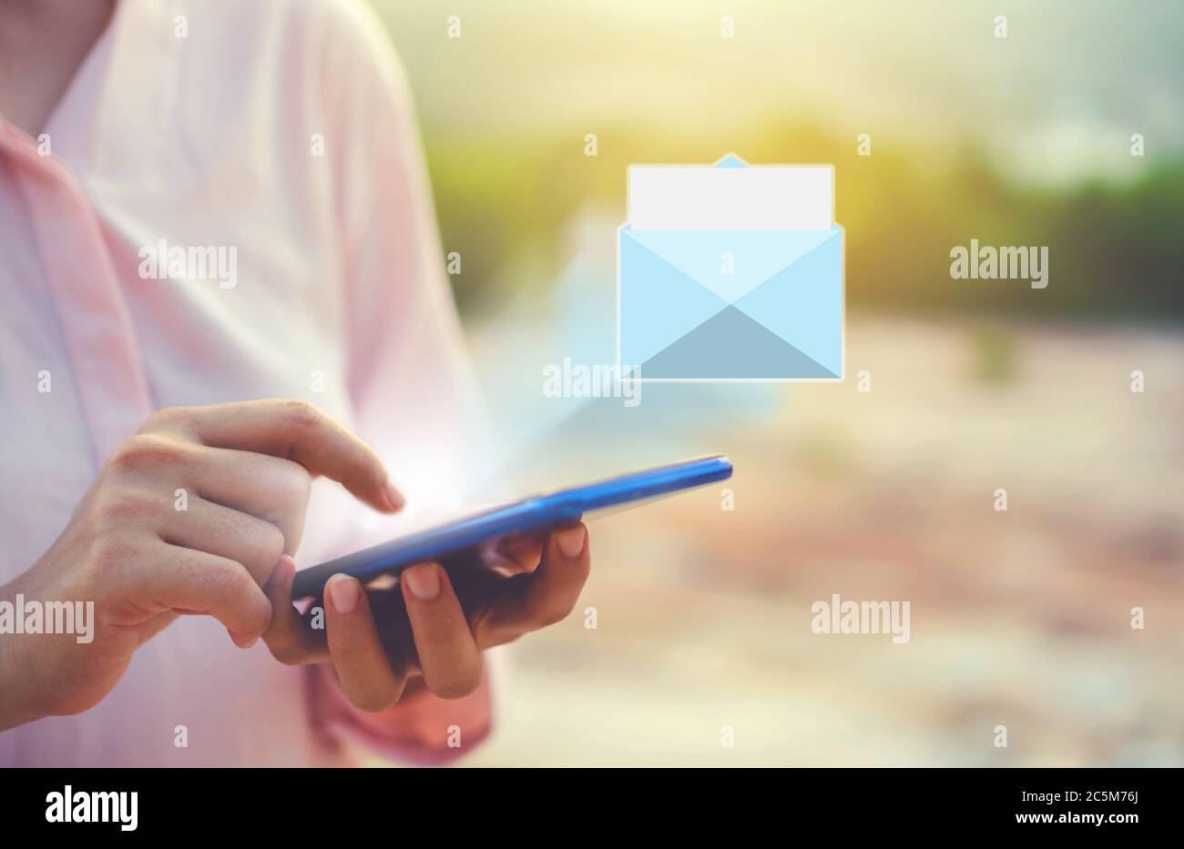 Woman hand using smartphone and it's show email recieve notification ...