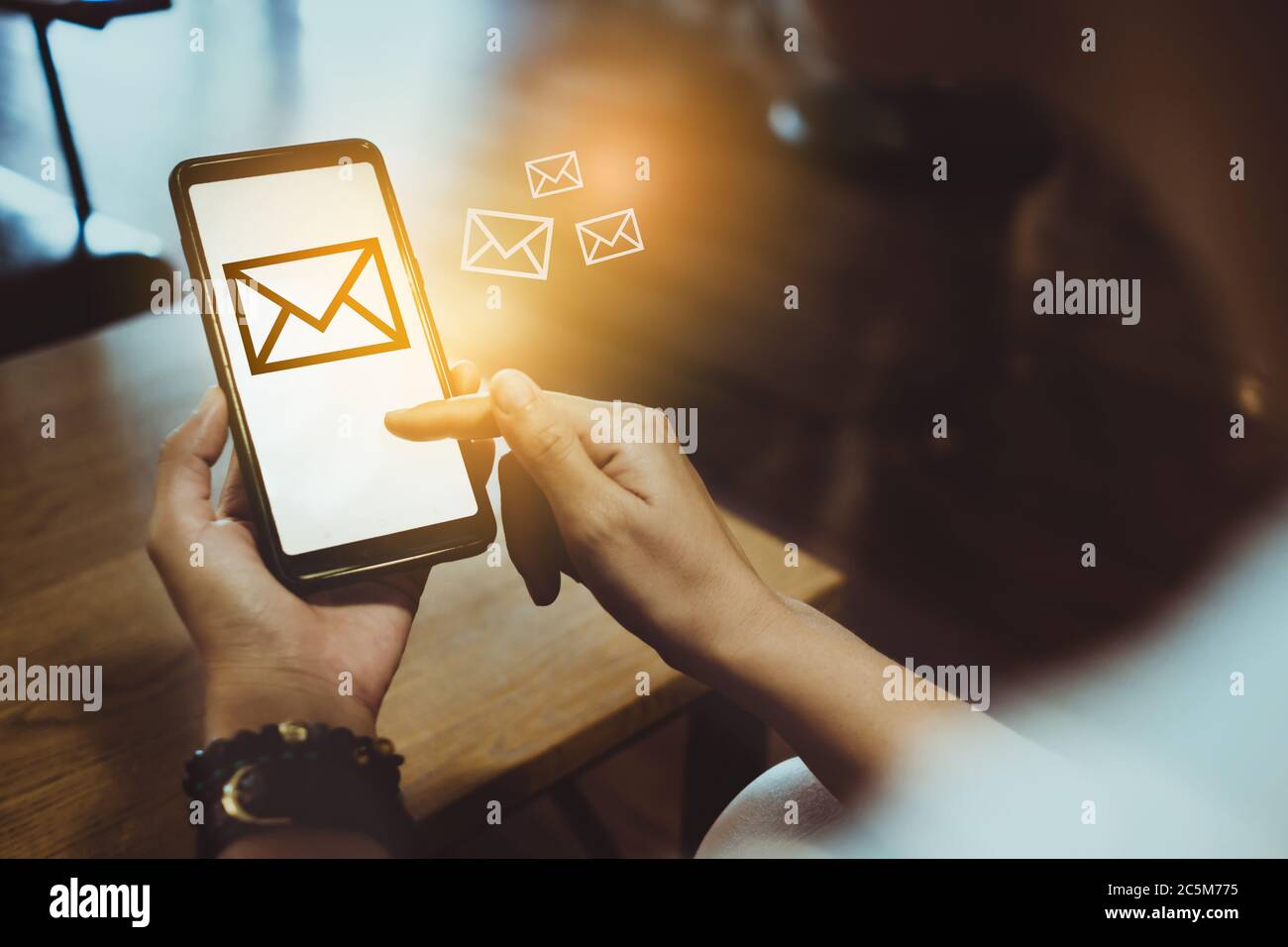 Woman hand using smartphone and it's show email recieve notification ...
