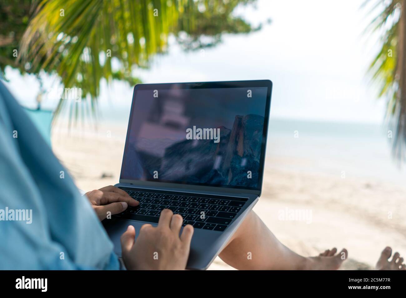 Woman using laptop and smartphone to work study in vacation cady at ...