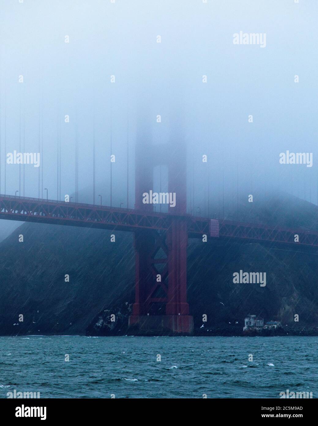 Moody photo of the Golden Gate Bridge from a Yacht. Foggy rainy day ...