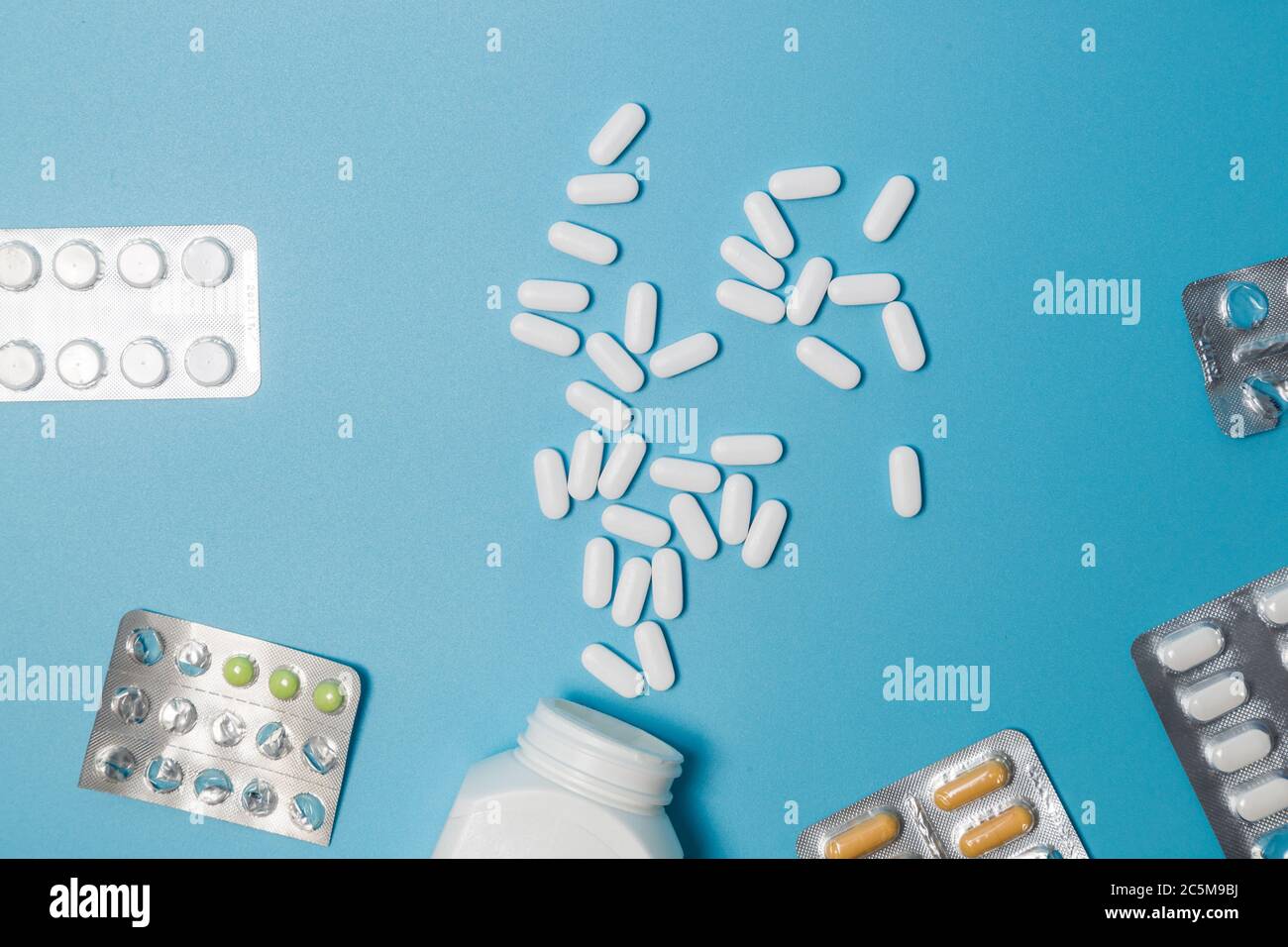 medical pills and tablets on blue background Stock Photo - Alamy