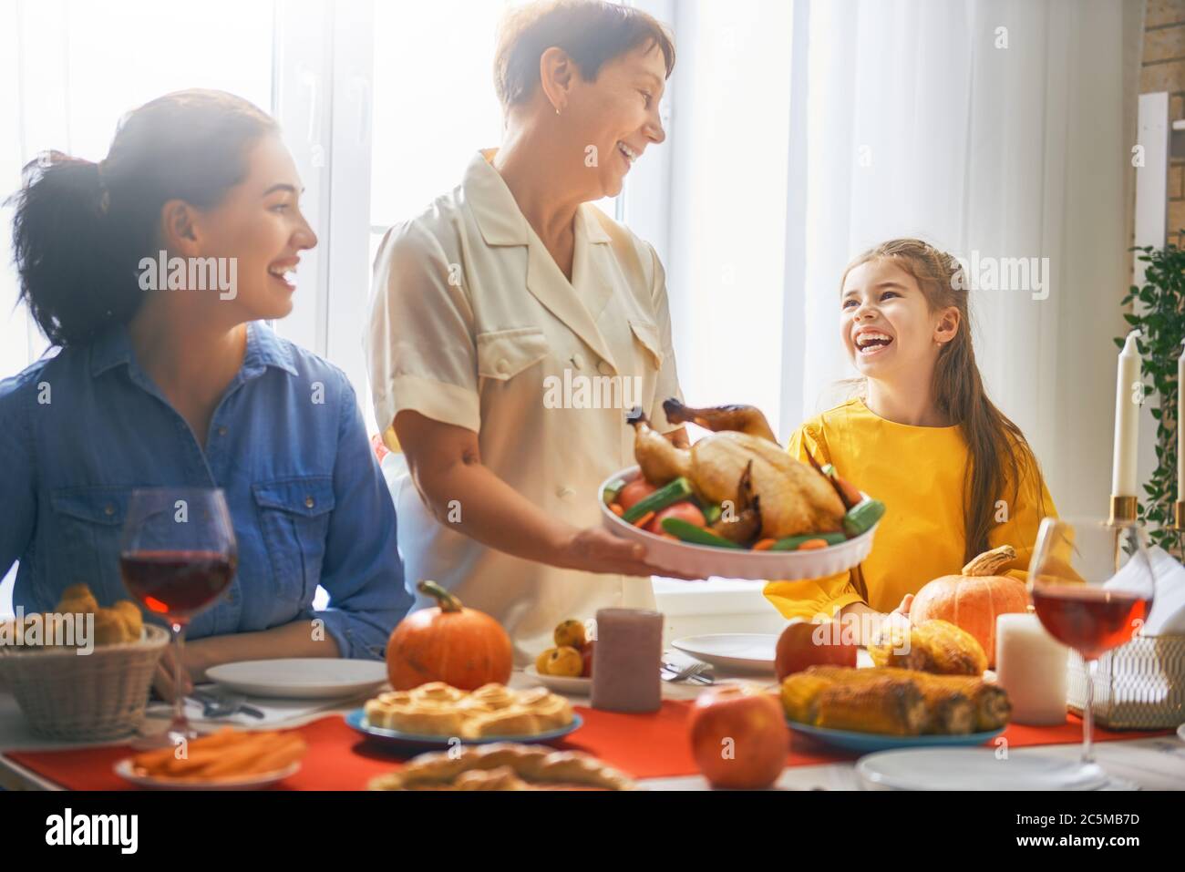 Happy Thanksgiving Day! Autumn feast. Family sitting at the table and ...
