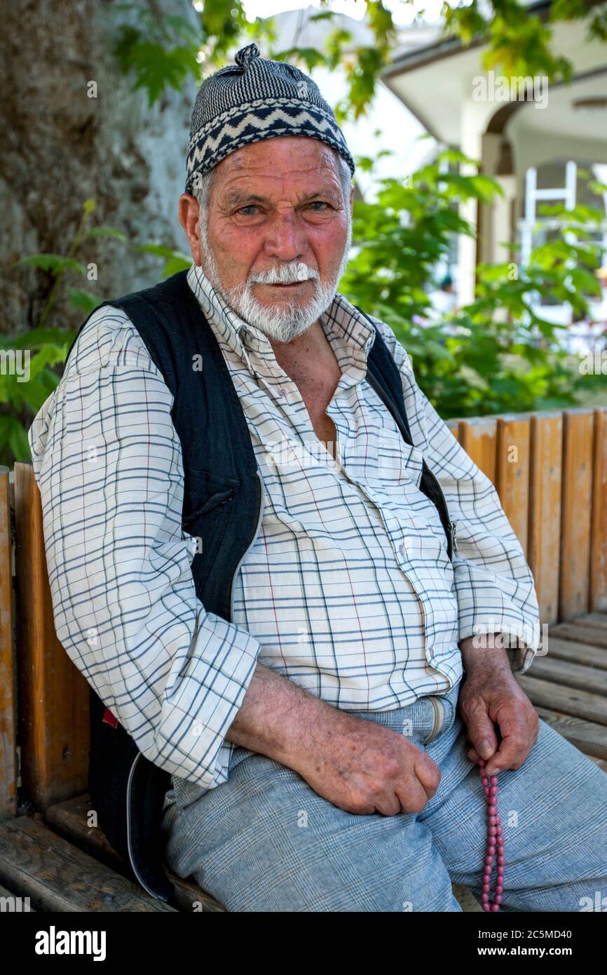 A Turkish man sits outside the Ketenci Omer Pasha Camii(mosque) in the ...